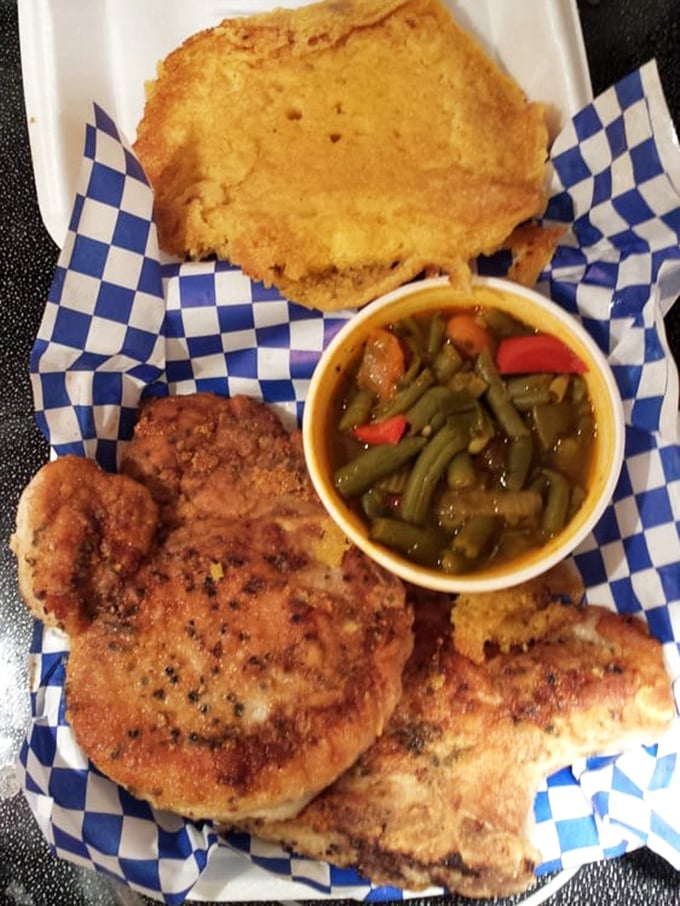 This isn't just a pork chop—it's a masterclass in soul food perfection, served with cornbread and green beans that would make your grandmother nod in approval.