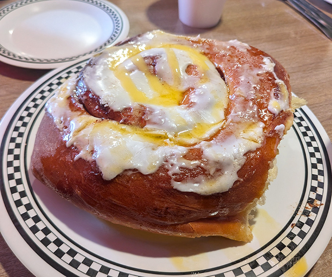 Behold the holy grail of breakfast pastries. This cinnamon roll isn't just food—it's an event, with glaze cascading down spirals of cinnamon-sugar perfection.