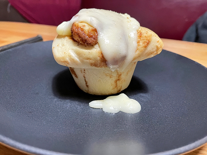 This cinnamon roll isn't just breakfast—it's an event. The frosting cascades down like a sweet avalanche that demands a moment of respectful silence.