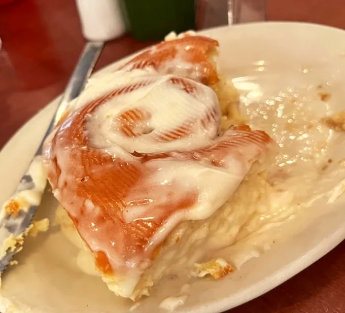 Behold the holy grail of breakfast pastries—a cinnamon roll so perfectly iced it makes you question every other cinnamon roll relationship you've ever had.