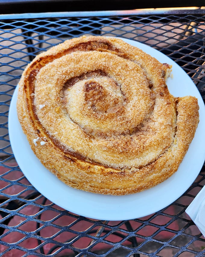 Behold the cinnamon roll in its natural habitat – a spiral of buttery, sugar-dusted perfection that makes all other breakfast pastries bow in respect.