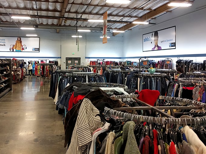 Racks upon racks of clothing create a textile library spanning decades of fashion history, each garment with its own story to tell.