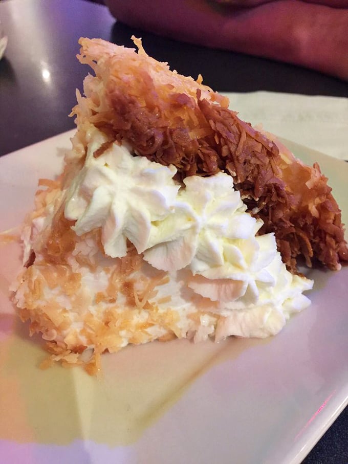 Behold the legendary coconut cream pie—a cloud of whipped cream atop toasted coconut perfection that would make your grandmother weep with joy.
