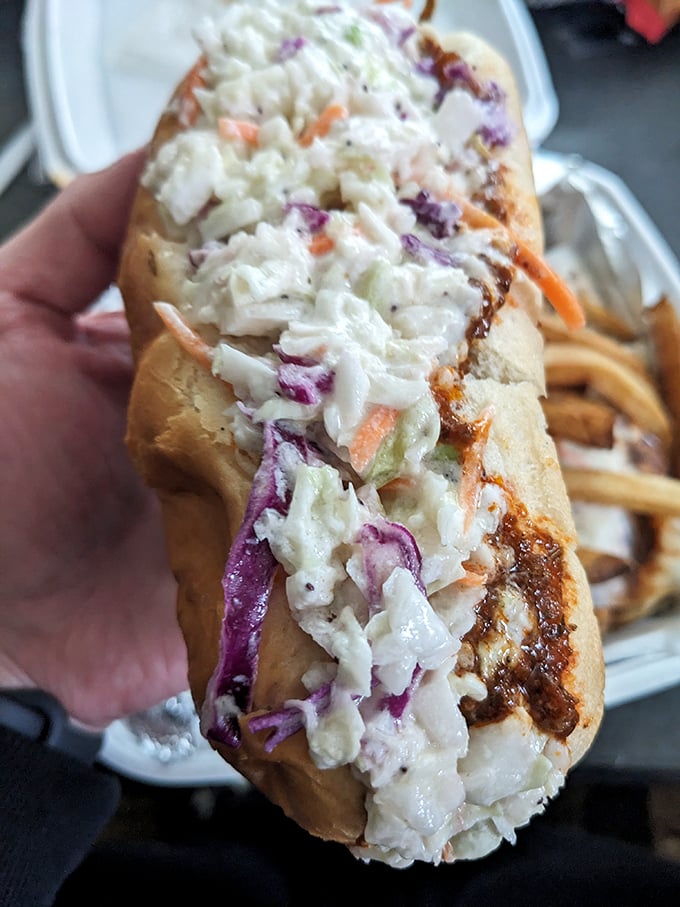 Behold the star attraction: a perfect coney dog smothered in that colorful, crunchy slaw that elevates this from snack to legend.