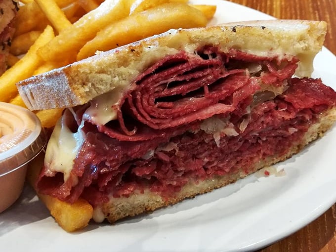 Behold the star of the show—a corned beef sandwich so perfect it deserves its own ZIP code. Thinly sliced, perfectly stacked, and flanked by golden fries.