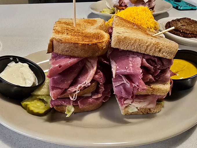 This isn't just a sandwich—it's a skyscraper of corned beef requiring structural engineering and a serious jaw workout. Worth every bite.