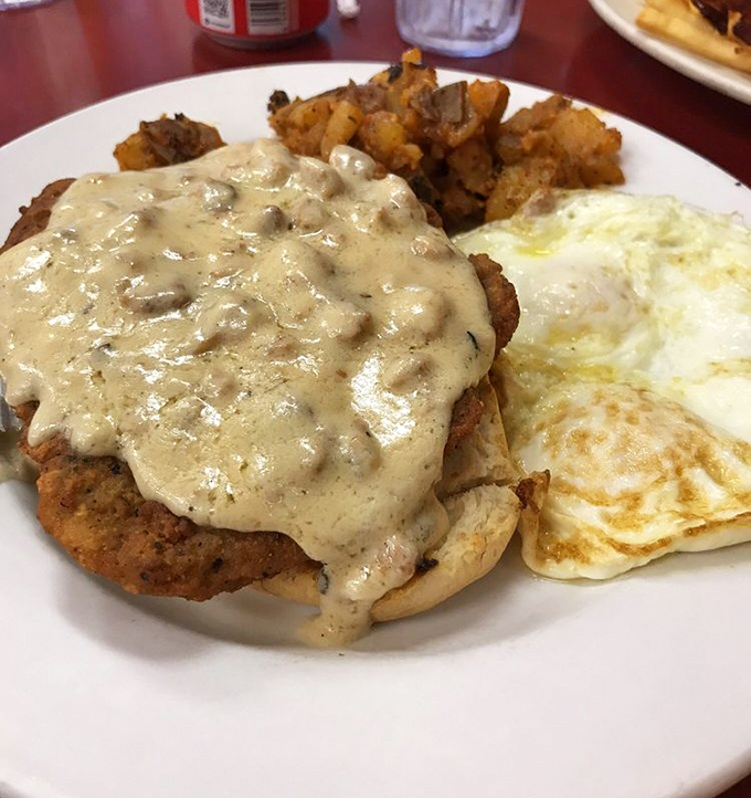 The legendary country fried steak arrives like royalty under a crown of peppery gravy, with eggs and home fries as its loyal courtiers.
