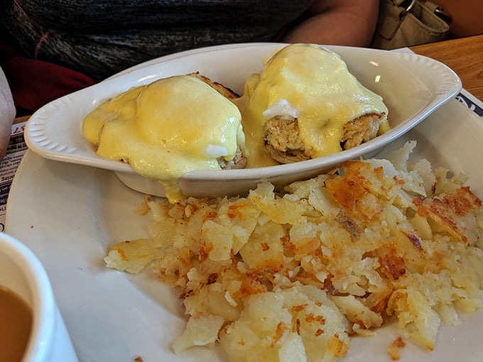 The legendary Crab Benedict in all its glory. Two golden-topped treasures surrounded by perfectly crisped home fries—breakfast nirvana achieved.