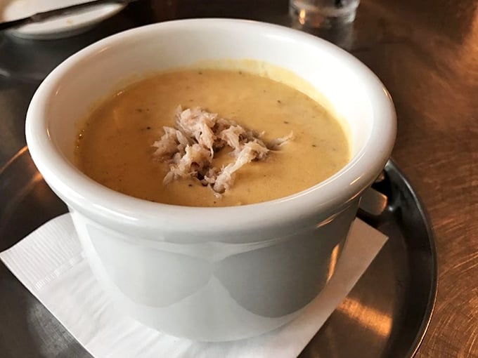 The crab bisque arrives like a warm hug in a bowl. That generous portion of lump crab meat isn't garnish—it's the treasure beneath the creamy waves.