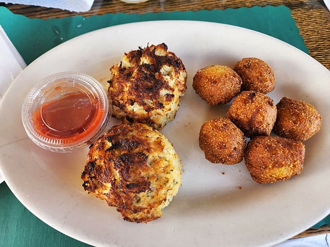 Behold the star attraction: golden-brown crab cakes with minimal filler and maximum flavor, served with hush puppies that demand attention.