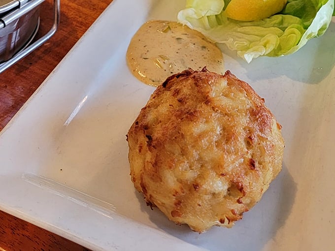 Behold, the star of the show! This golden-brown crab cake is what food dreams are made of—almost too beautiful to eat. Almost.