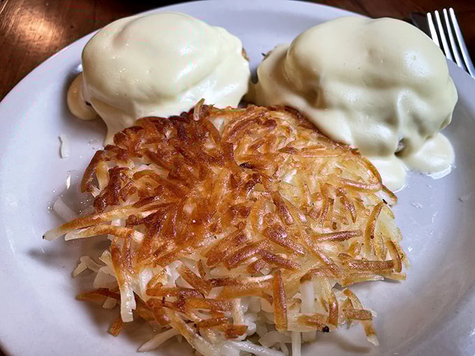 Behold the star of our show: the Crab Cake Benedict. Those golden hash browns deserve their own fan club, while the hollandaise blankets everything in silky perfection.