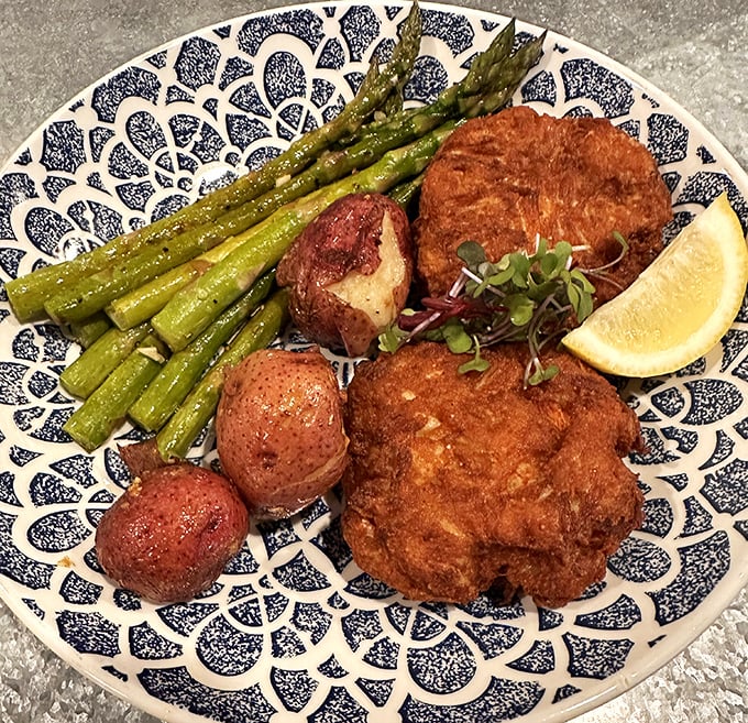 Golden-fried perfection meets fresh asparagus in this plate symphony. The crab cakes at JP's don't hide behind fillers—they proudly showcase Delaware's briny bounty.
