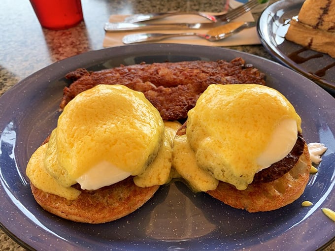 Two golden-domed poached eggs perched atop crab cakes—this Benedict doesn't just break your fast, it shatters expectations of airport-adjacent dining.
