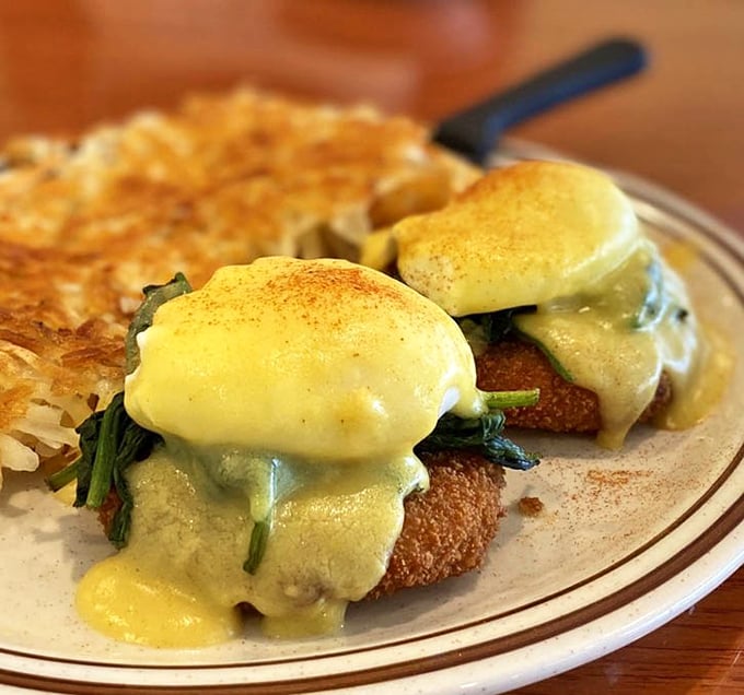 Behold the star attraction: golden crab cakes crowned with poached eggs and draped in hollandaise—breakfast architecture at its finest.