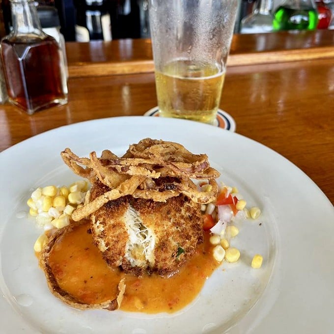 This crab cake isn't just a dish—it's an event, crowned with crispy wisps and surrounded by a moat of sauce you'll want to swim in.