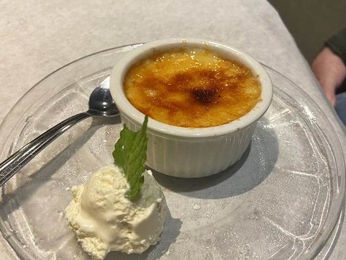Behold the star attraction: a perfectly caramelized creme brulee that makes that signature "crack" sound sweeter than breaking news.