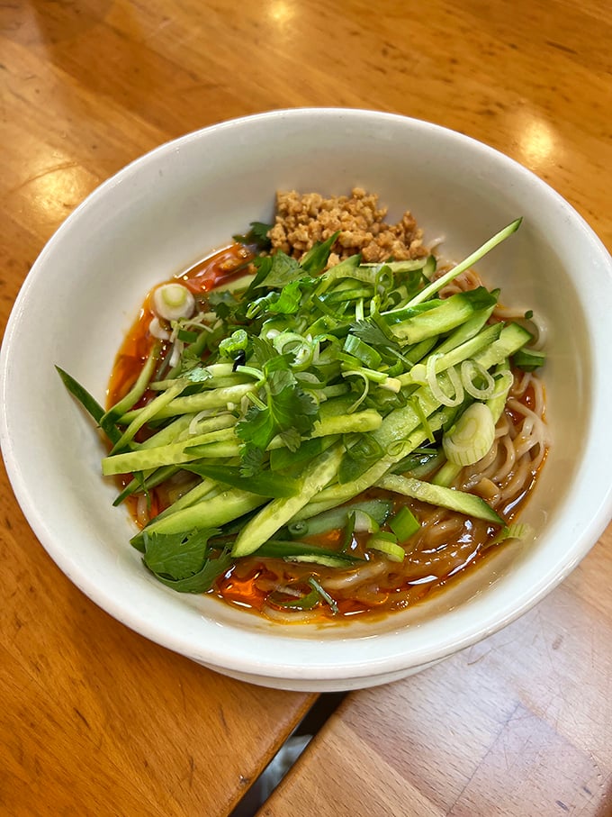 Behold: the dan dan noodles that launched a thousand road trips. Fresh cucumber, vibrant herbs, and that sauce—oh, that sauce—creating a bowl of noodle nirvana worth crossing state lines for.