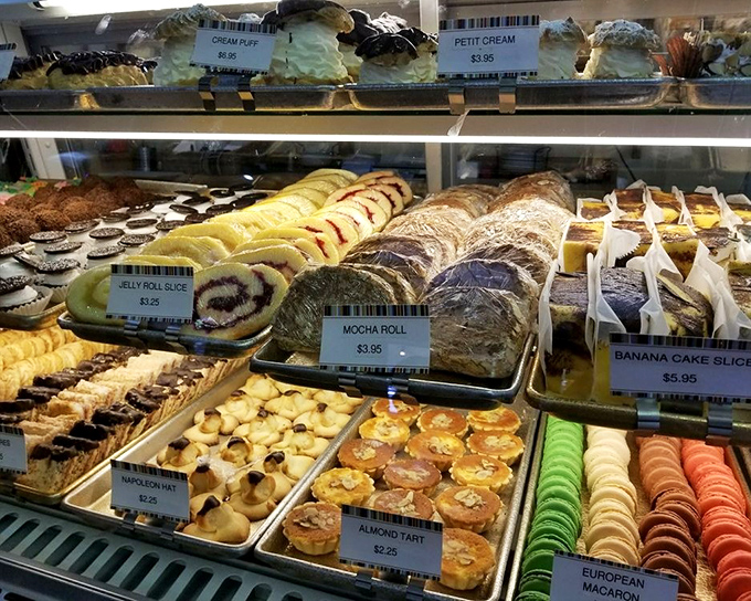 Pastry paradise isn't a myth—it exists behind glass at Birkholm's, where cream puffs, jelly rolls, and almond tarts compete for your attention like contestants on a delicious reality show.