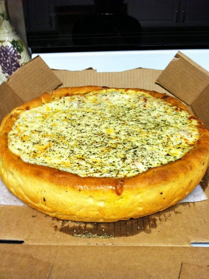 This deep-dish masterpiece sports a golden crown of crust that's halfway between bread and pastry – architecture you can eat.