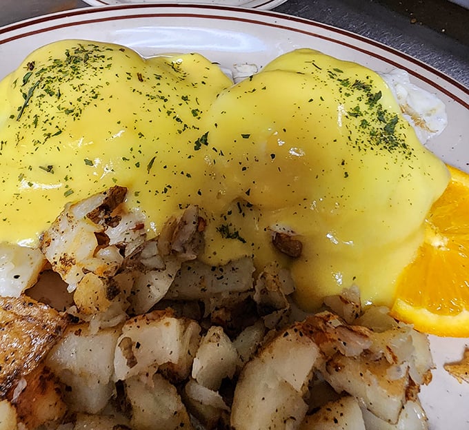 Behold the star attraction – hollandaise cascading over perfectly poached eggs like a sunrise over the Delaware countryside. Poetry on a plate.