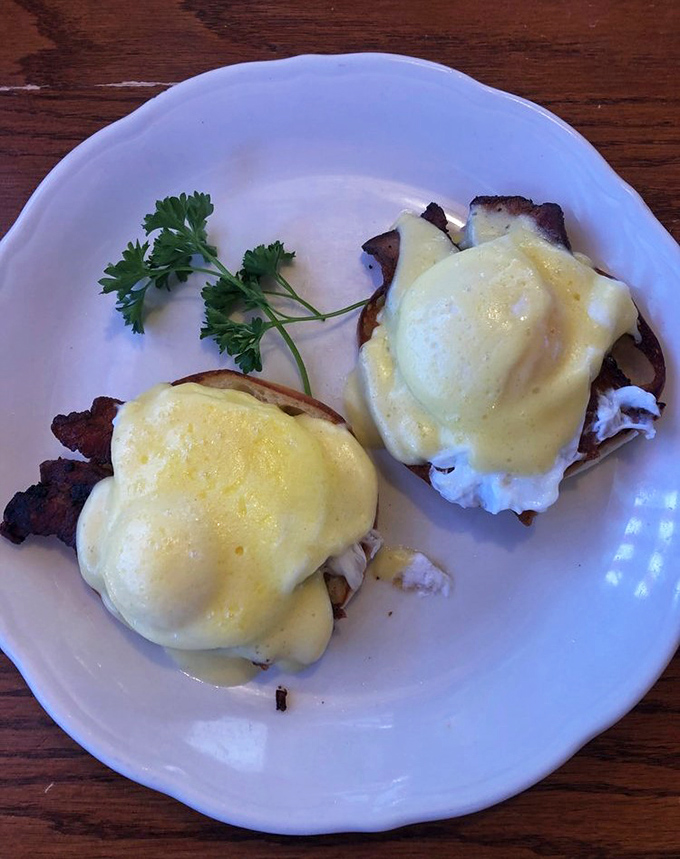 Behold the star attraction – Eggs Benedict with hollandaise cascading like golden velvet over perfectly poached eggs and Canadian bacon.