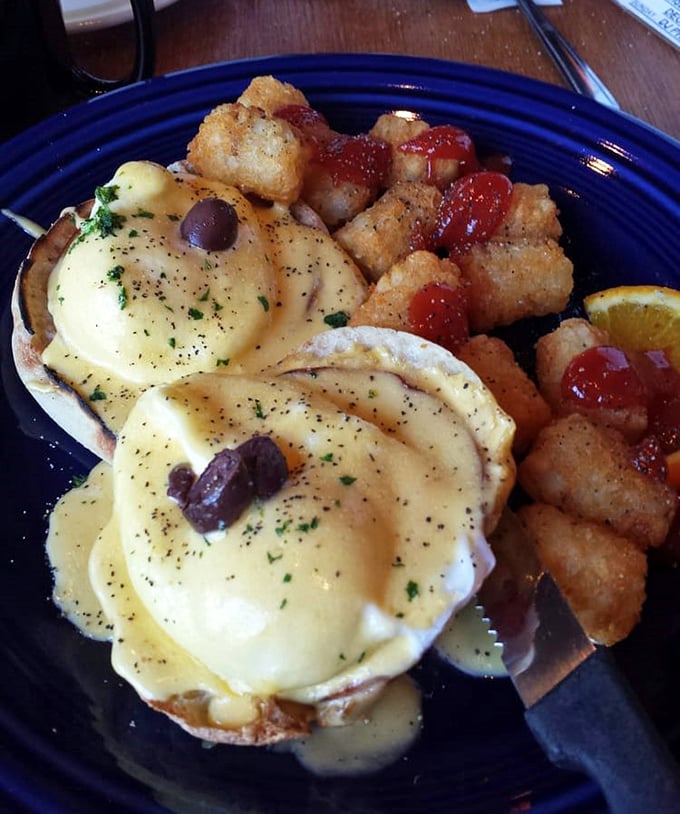 Behold the holy grail of breakfast: eggs benedict with hollandaise cascading like a golden waterfall over perfectly poached eggs. Those home fries aren't just sidekicks—they're co-stars.