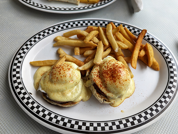 Eggs Benedict that would make a brunch snob weep with joy. Golden hollandaise cascading over English muffins like a breakfast waterfall.