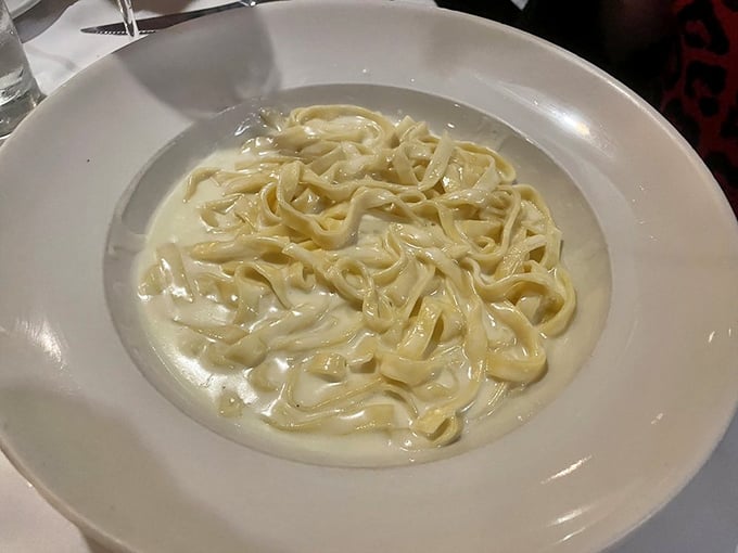 Behold, the star of the show—fettuccine Alfredo so creamy it should come with a warning label: "May cause involuntary food moans."