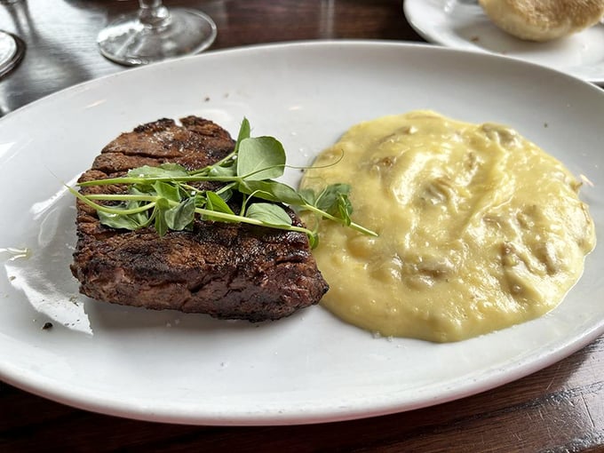 Behold the star attraction—a perfectly seared filet mignon alongside creamy mashed potatoes. This isn't just dinner; it's a religious experience.