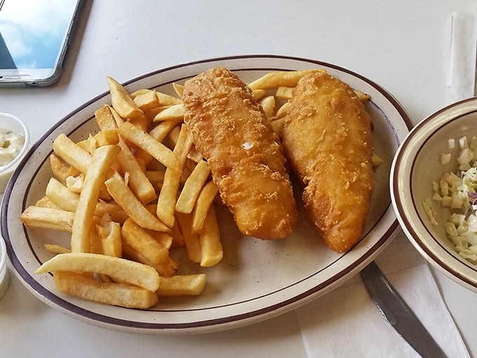 Golden-battered fish that shatters with each bite, paired with fries that achieve the perfect balance between crisp exterior and fluffy interior.