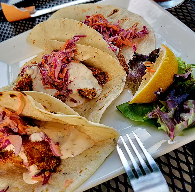 Behold the legendary fish fry tacos! Cornmeal-crusted perch nestled in flour tortillas with that vibrant slaw – Wisconsin tradition gets a brilliant makeover.