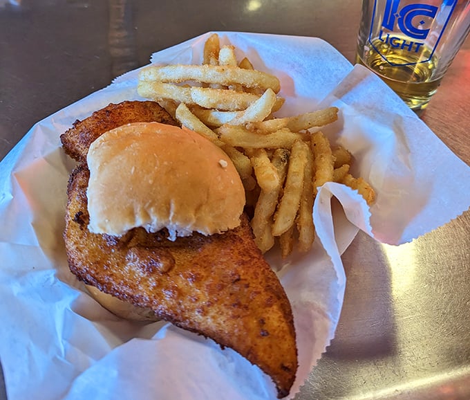 The legendary fish sandwich in all its glory—where the fish boldly declares independence from the bun's boundaries. This isn't food; it's edible architecture.