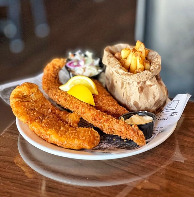Golden-battered fish that shatters with each bite, served alongside chips in a paper sack – this is seafood worth crossing state lines for.