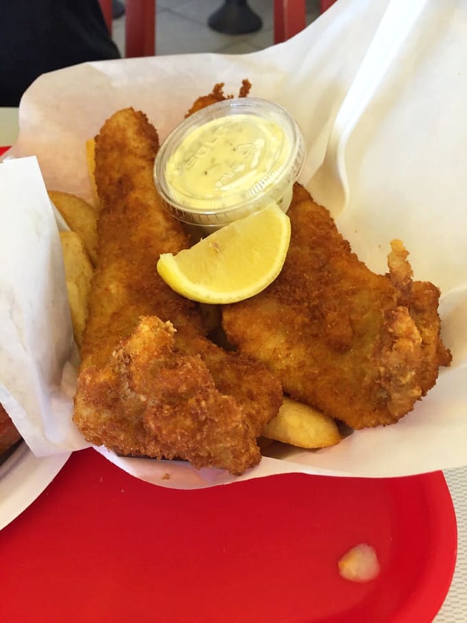 Golden-brown perfection on parchment paper – the sourdough-battered fish practically whispers "eat me" with its crispy siren song.