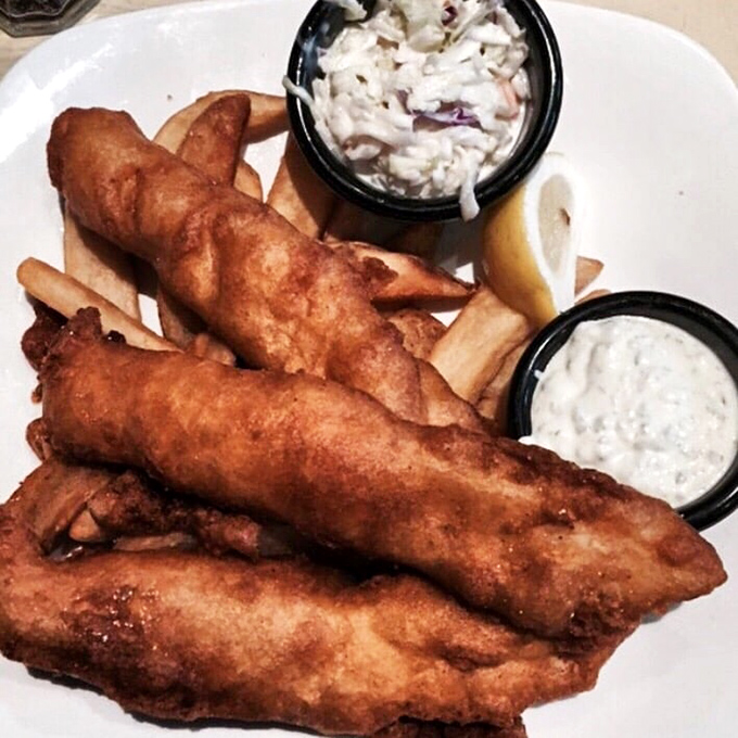 Golden-battered fish that shatters with each bite, paired with fries that deserve their own fan club. This isn't just fish and chips—it's edible poetry.