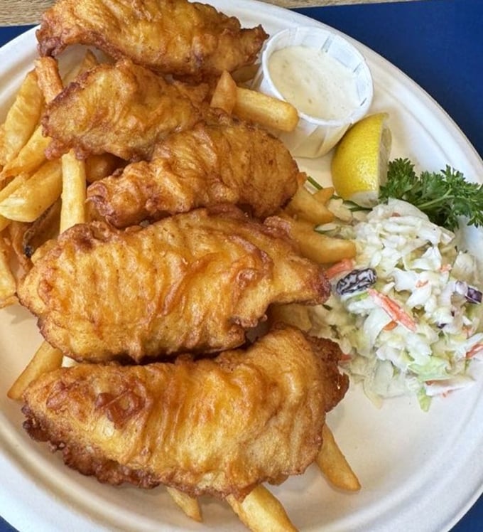 Golden-battered fish that shatters with each bite, alongside fries that actually taste like potato. This isn't just food—it's edible sunshine from the Pacific.