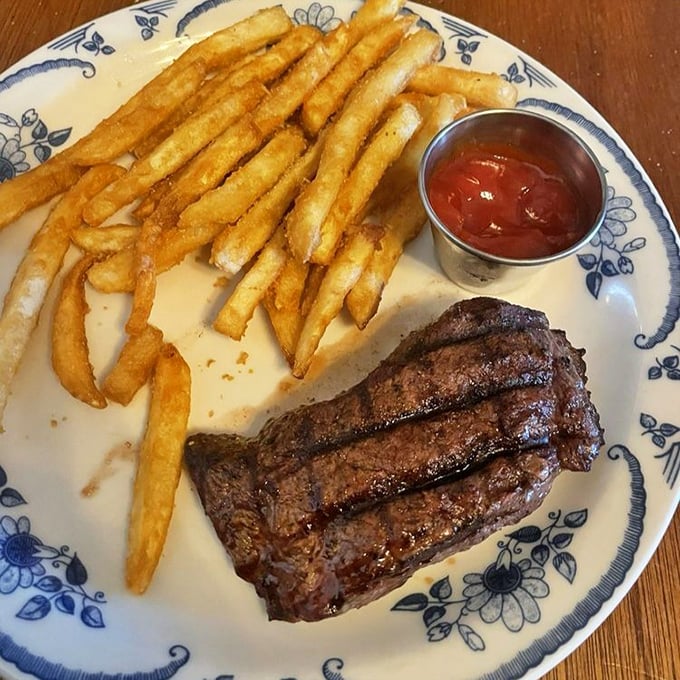 The star of the show: a perfectly seared flat iron steak with those textbook grill marks. Those golden fries aren't just sidekicks—they're worthy companions.