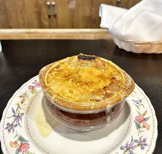 French onion soup that's worth the drive—a golden crown of bubbling Gruyère protecting a rich broth that's been simmering since you made your reservation.