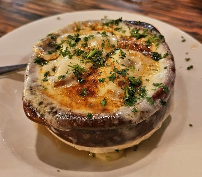 The French onion soup arrives like a cheese volcano waiting to erupt with flavor – this isn't just soup, it's an event.