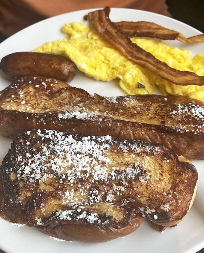 Golden-brown perfection dusted with powdered sugar – this french toast isn't just breakfast, it's a morning masterpiece worthy of your stretchy pants.