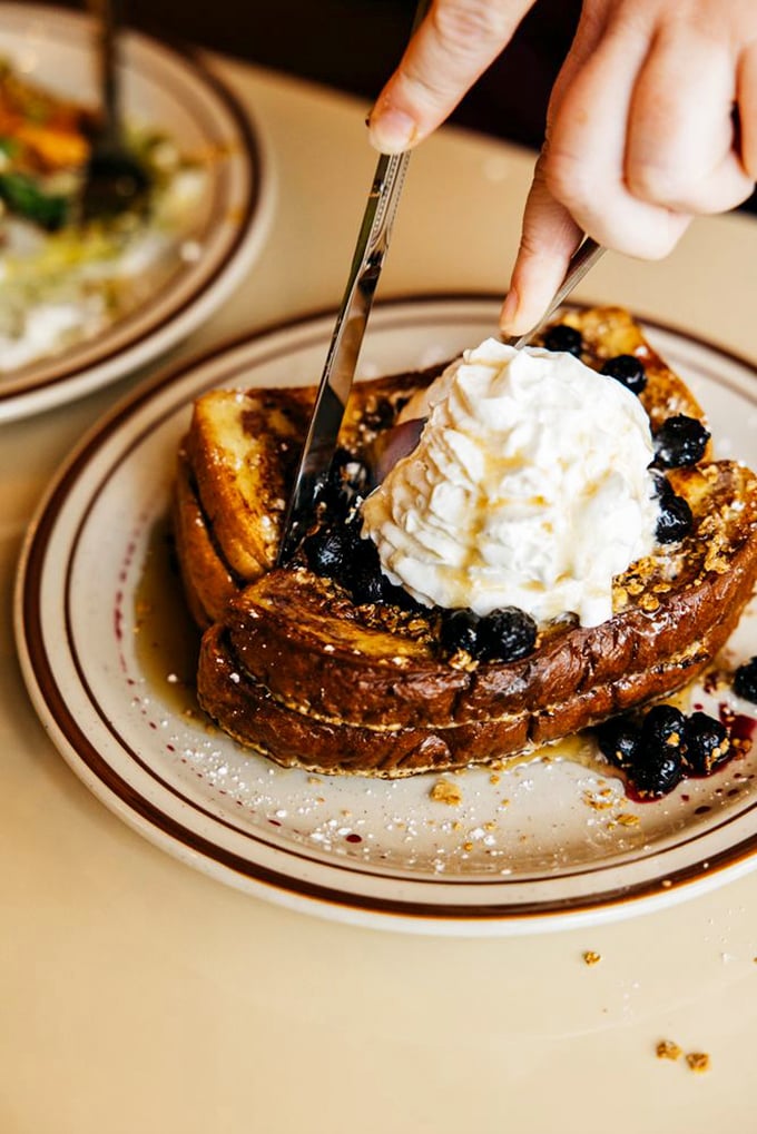 This isn't just French toast—it's a blueberry-crowned masterpiece with whipped cream that makes you wonder why you'd ever eat anything else for breakfast.