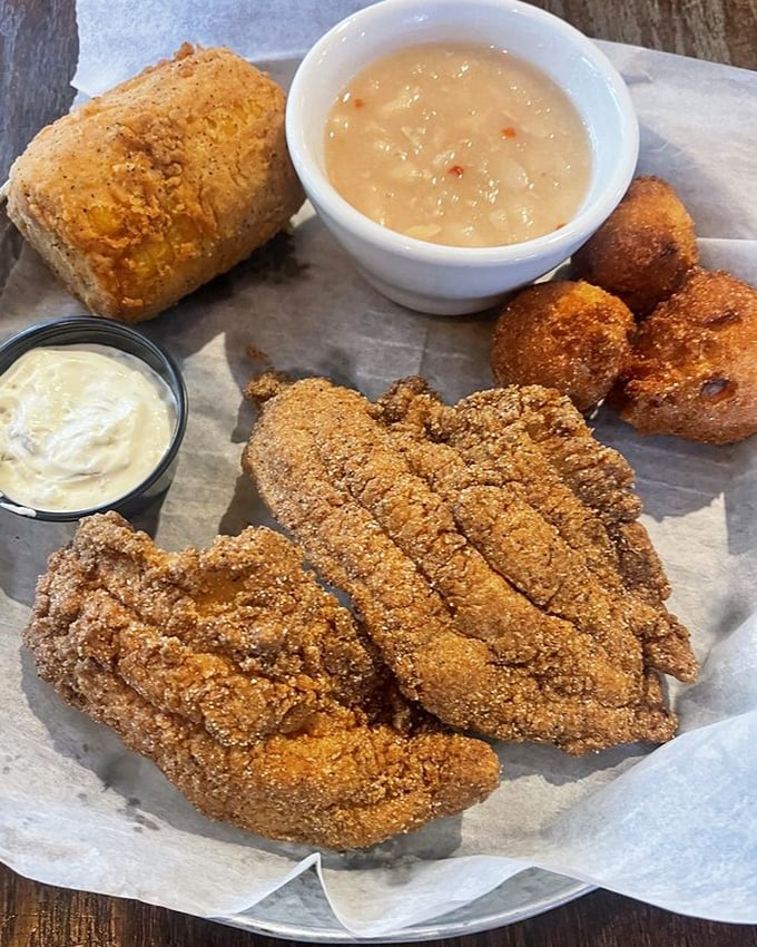 Golden-brown perfection! The cornmeal-crusted catfish strips arrive with hush puppies and white beans—a Tennessee trinity that makes taste buds stand at attention.