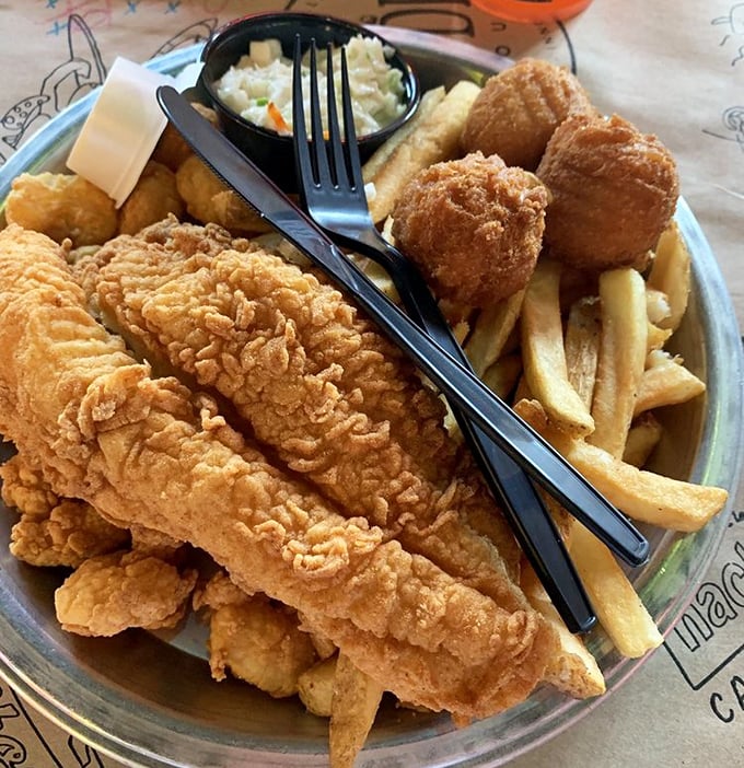 Golden-battered catfish that shatters with each bite, revealing pearly white flesh beneath. This isn't just fried fish – it's edible Southern poetry.