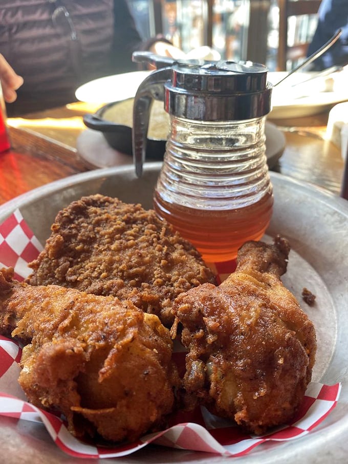 Golden-brown perfection with that signature spicy honey on standby. This isn't just fried chicken—it's a masterclass in crunch-to-juicy ratio engineering.