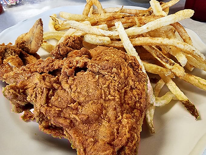 Golden-brown perfection meets crispy, crackling skin – this fried chicken with hand-cut fries might just be worth crossing state lines for.