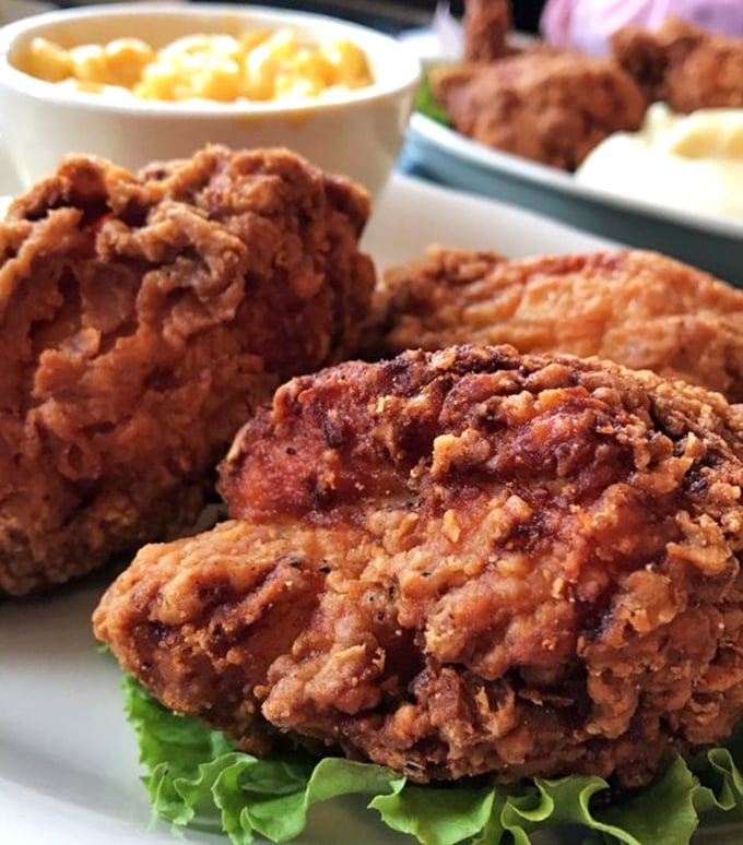 Fried chicken so perfectly golden and craggy, it makes you wonder if they've somehow found a way to fry happiness itself.