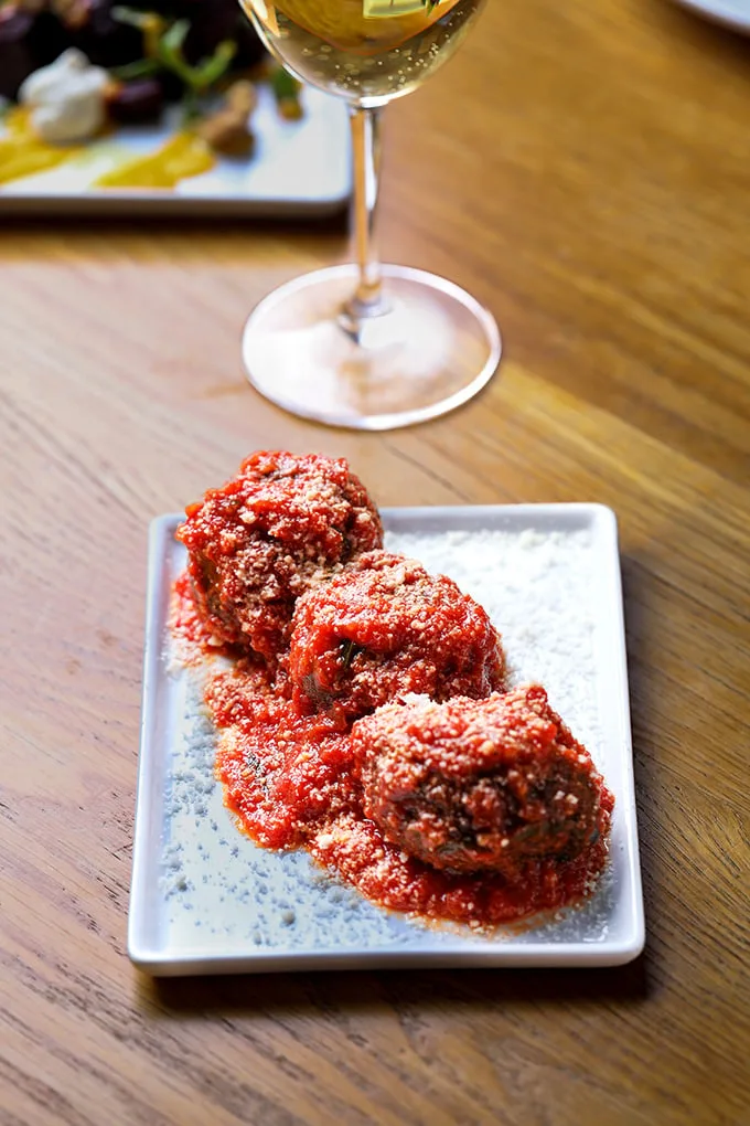 These aren't your average meatballs—they're flavor bombs of perfectly seasoned goodness swimming in a vibrant tomato sauce that demands bread for sopping.