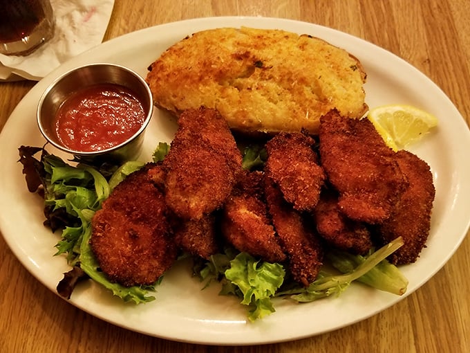 These golden-fried oysters aren't just appetizers—they're little crispy jewels of the sea, served with a cornbread sidekick that deserves its own fan club.