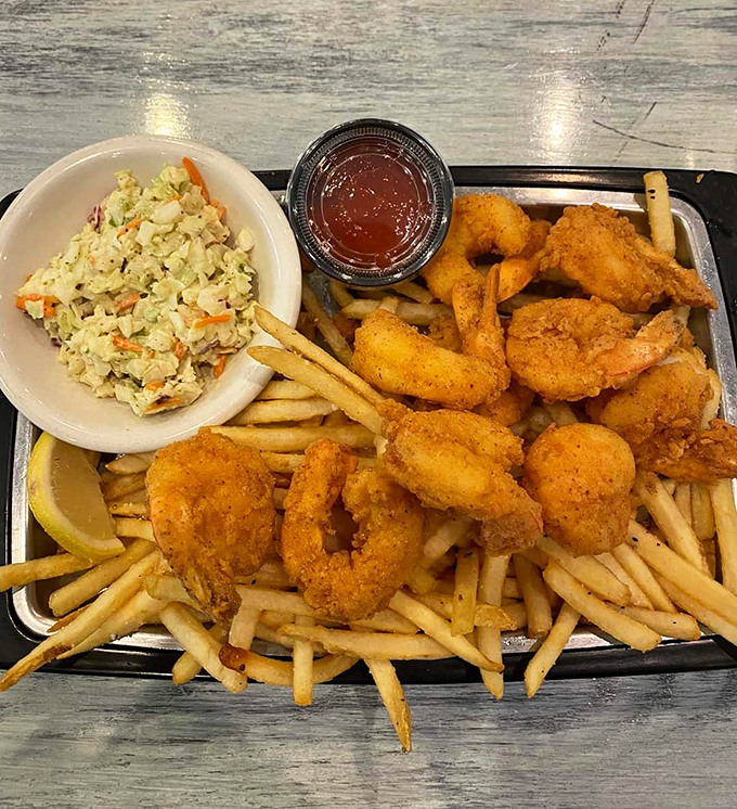 Golden, crispy, and piled high with fries—this is what fried shrimp dreams are made of, folks.